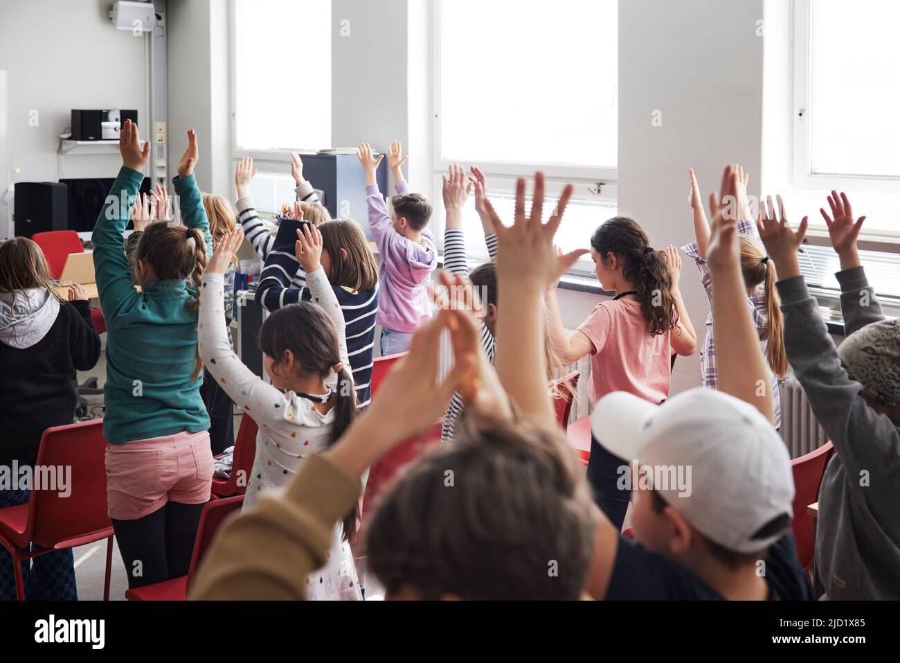 Children raising hands in class Stock Photo - Alamy