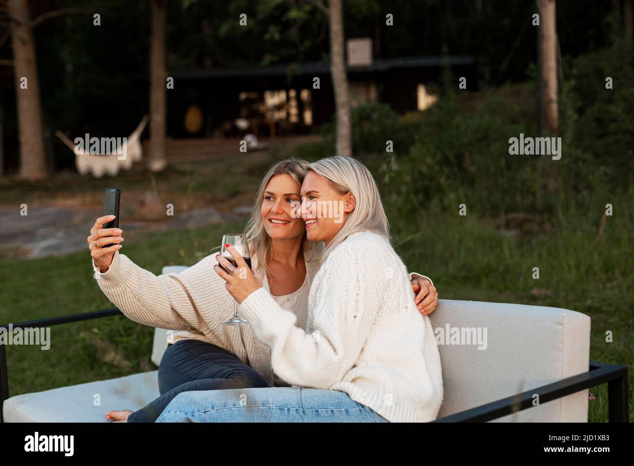 Female friends taking selfie on bench Stock Photo - Alamy Female friends taking selfie on bench Stock Photo - Alamy