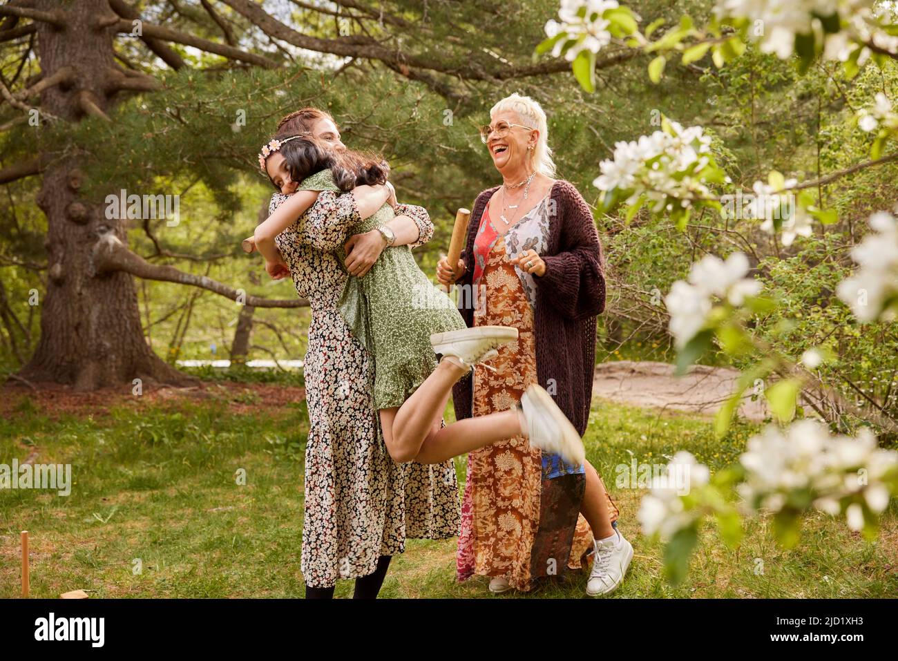 Mother hugging daughter outdoors Stock Photo - Alamy