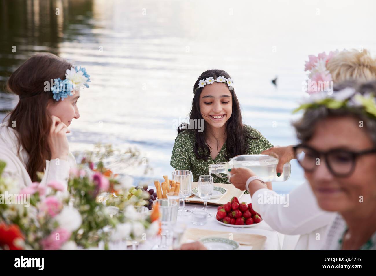 Family having midsummer dinner by lake Stock Photo - Alamy