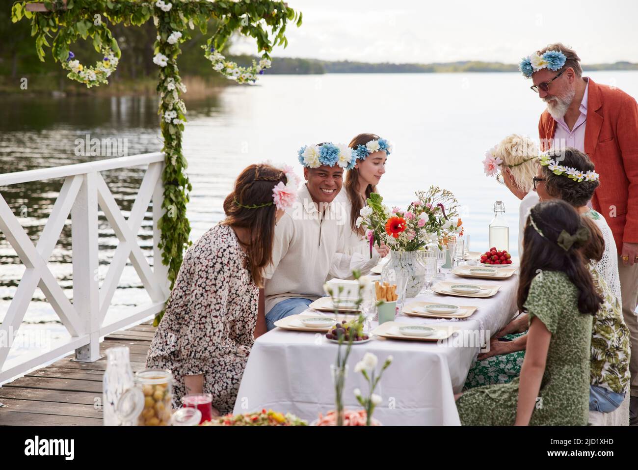 Family having midsummer dinner by lake Stock Photo - Alamy