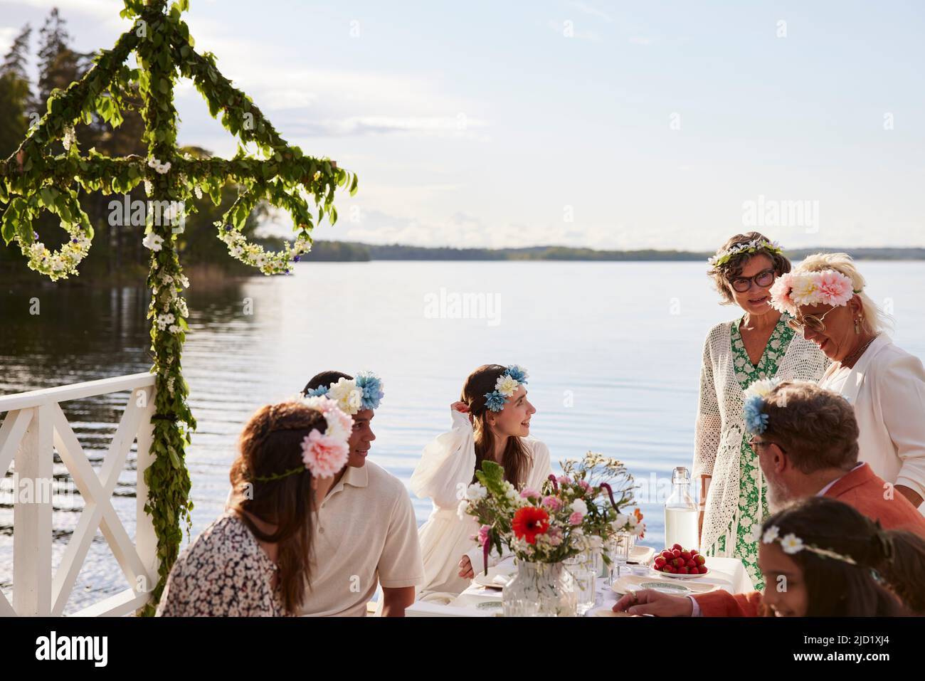 Family having midsummer dinner by lake Stock Photo - Alamy