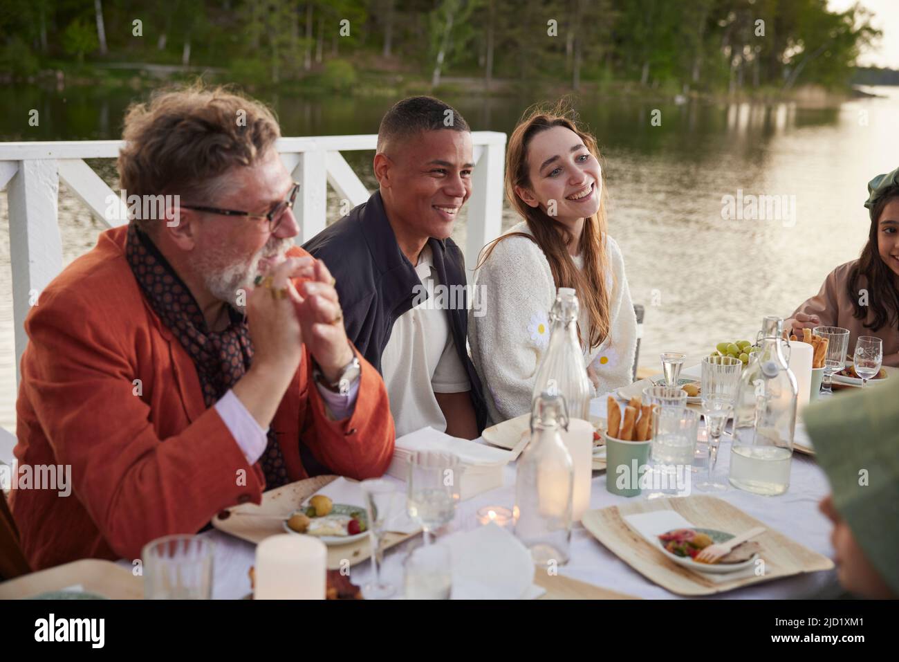 Family having dinner by lake Stock Photo - Alamy