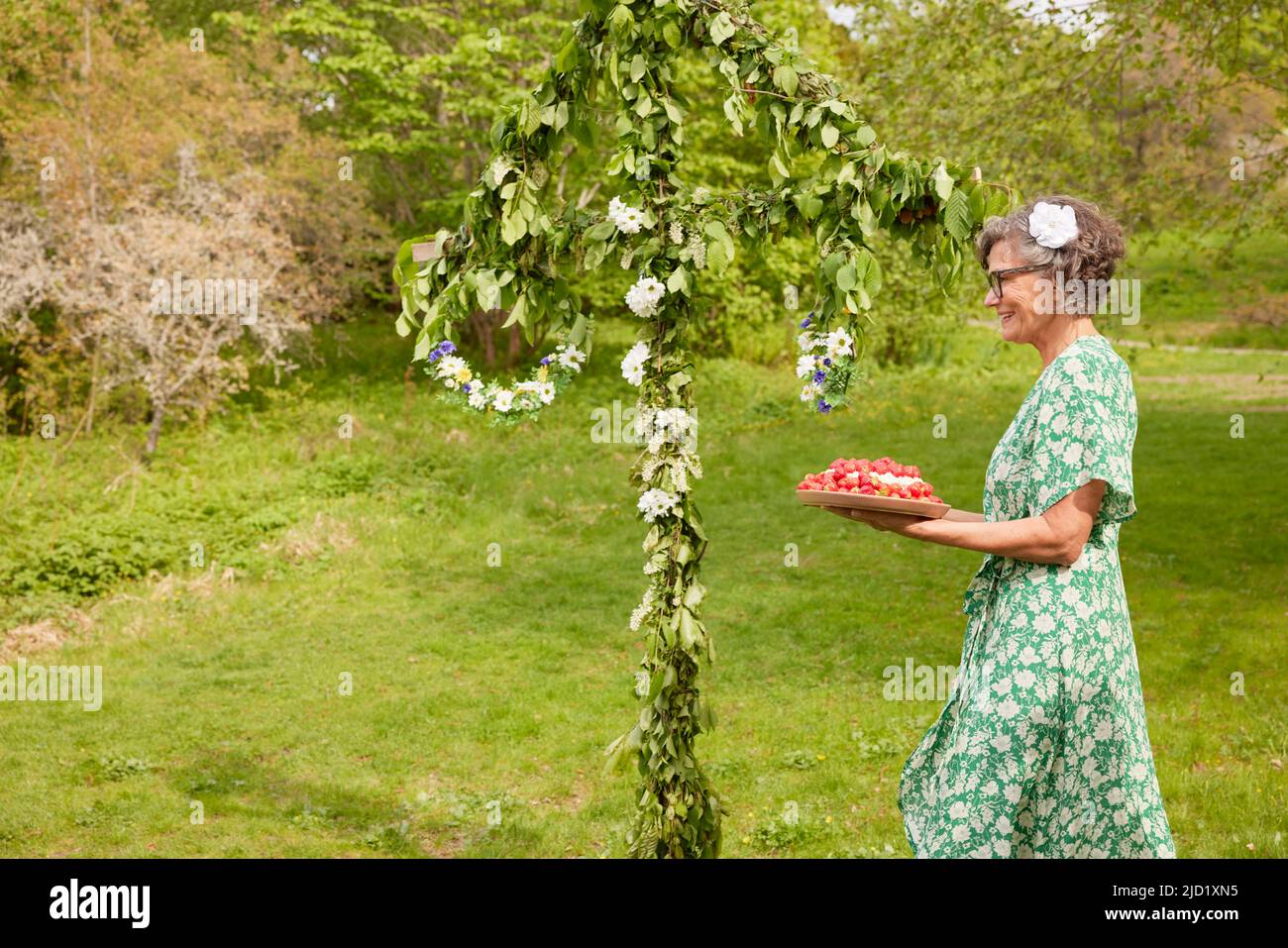 Woman carrying cake outdoors Stock Photo - Alamy