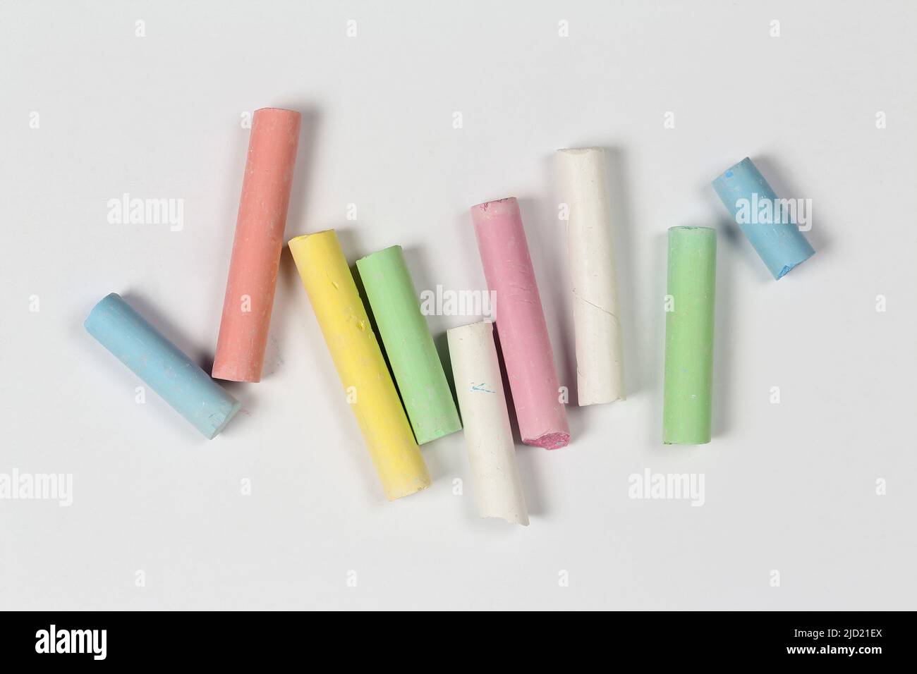 colorful chalk pieces on white paper, top view Stock Photo - Alamy