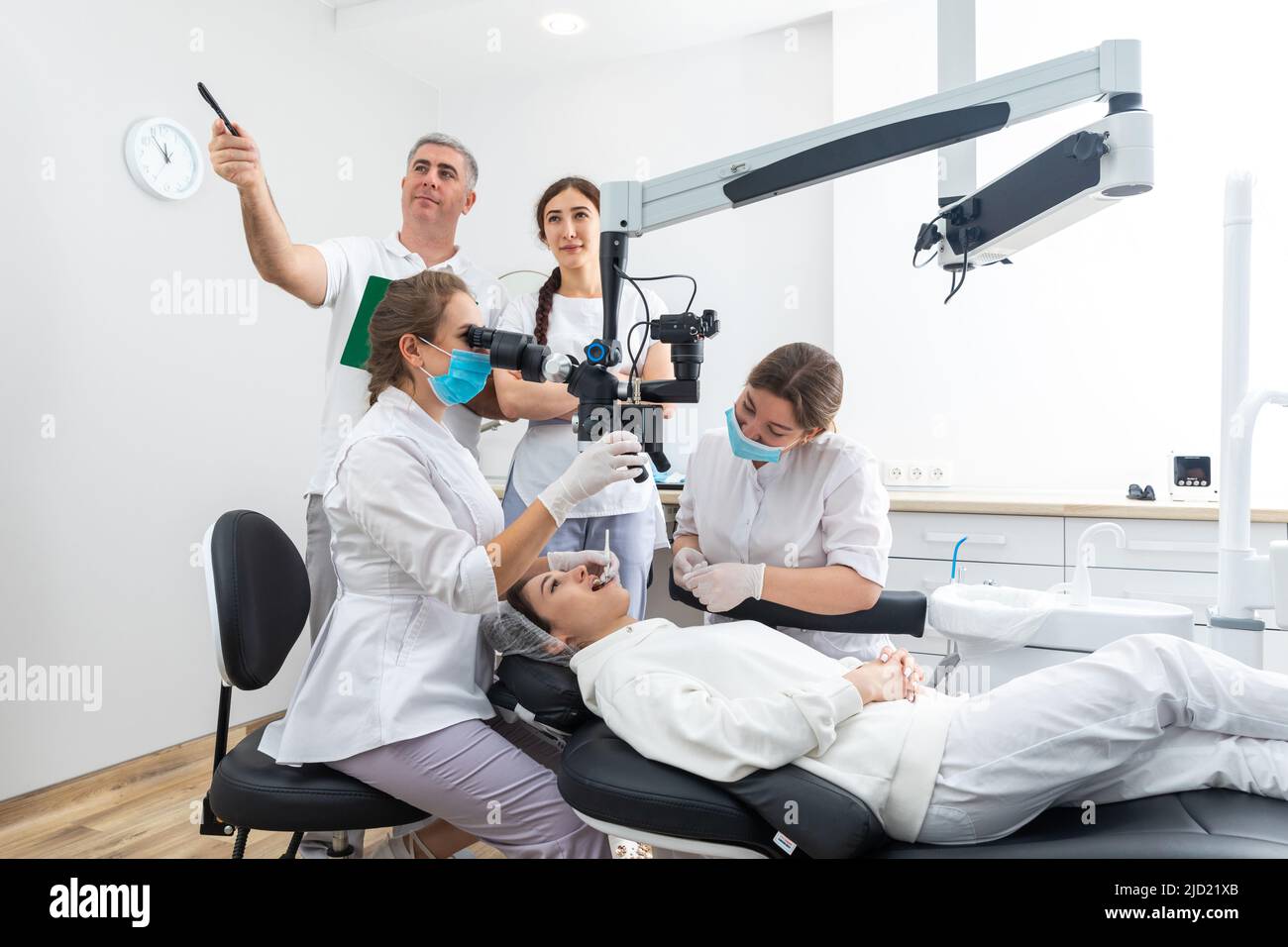 Group of young doctors learning in dental clinic watching dental ...