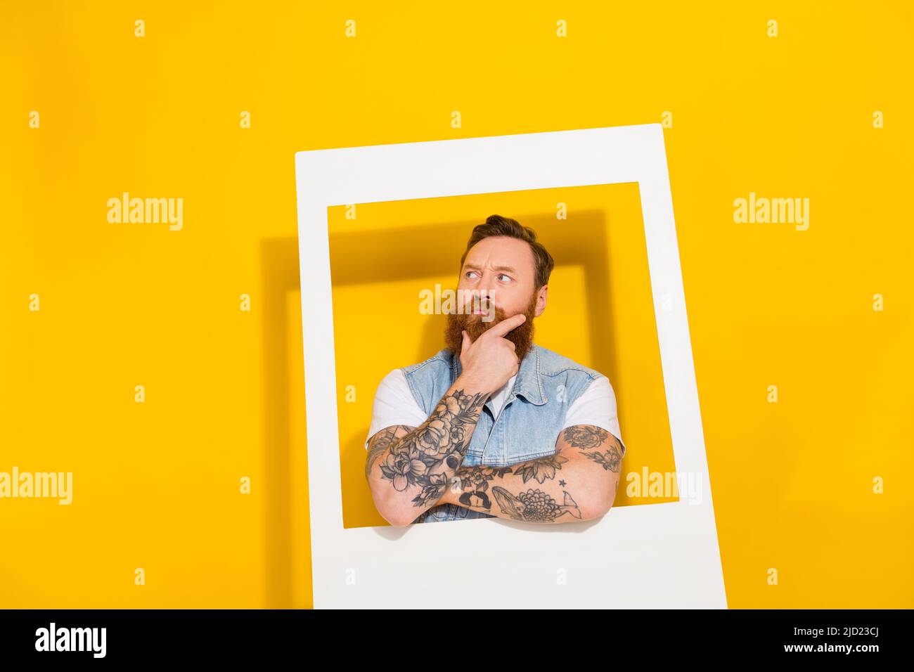 Portrait of serious minded person hand touch chin look empty space ...