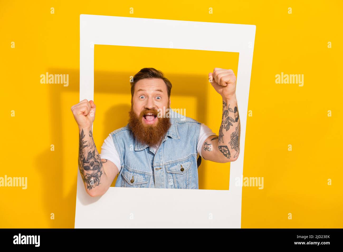 Portrait of satisfied astonished person raise fists look through paper ...