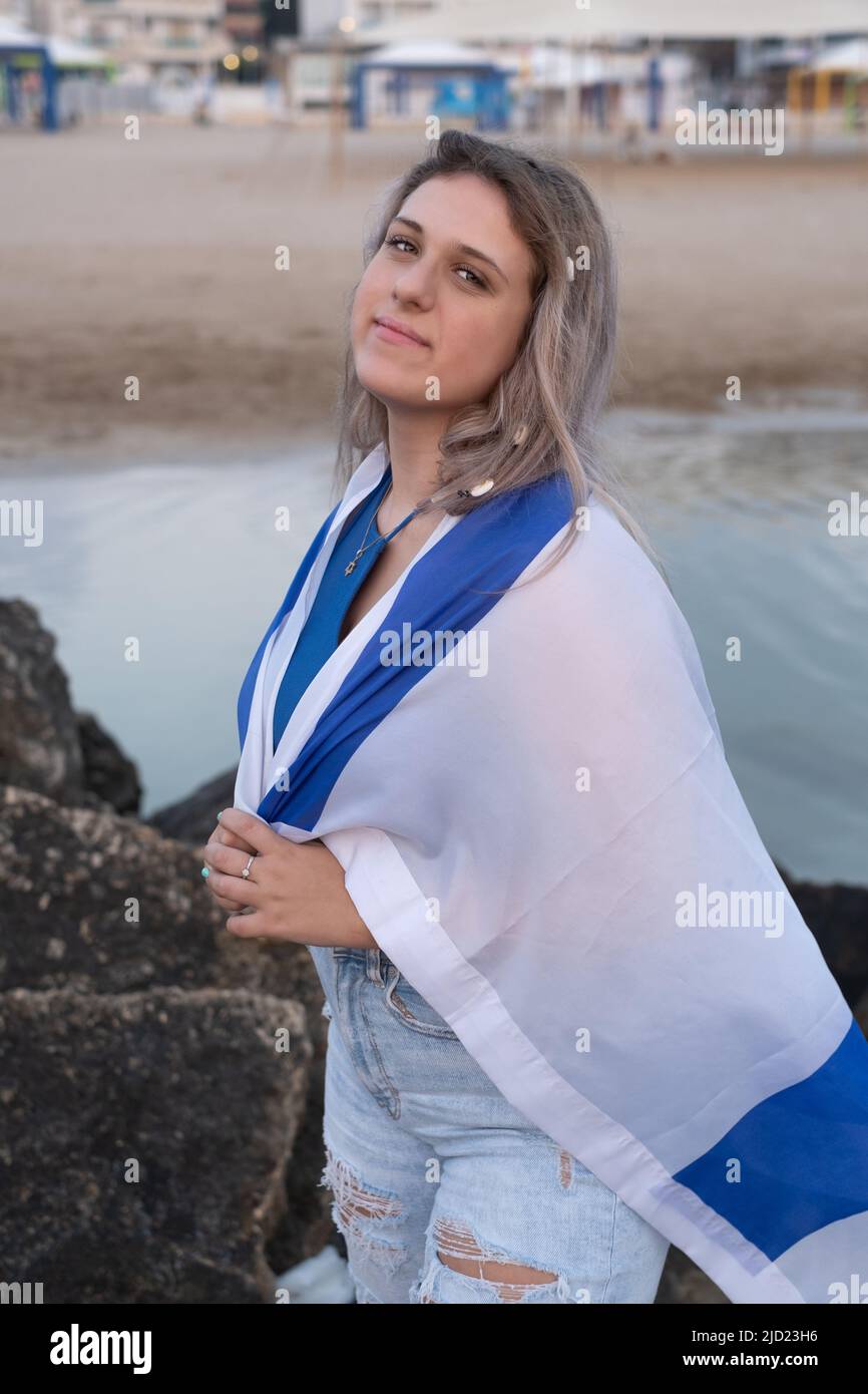 Portrait of Israeli Teen young woman with the Flag of Israel draped ...
