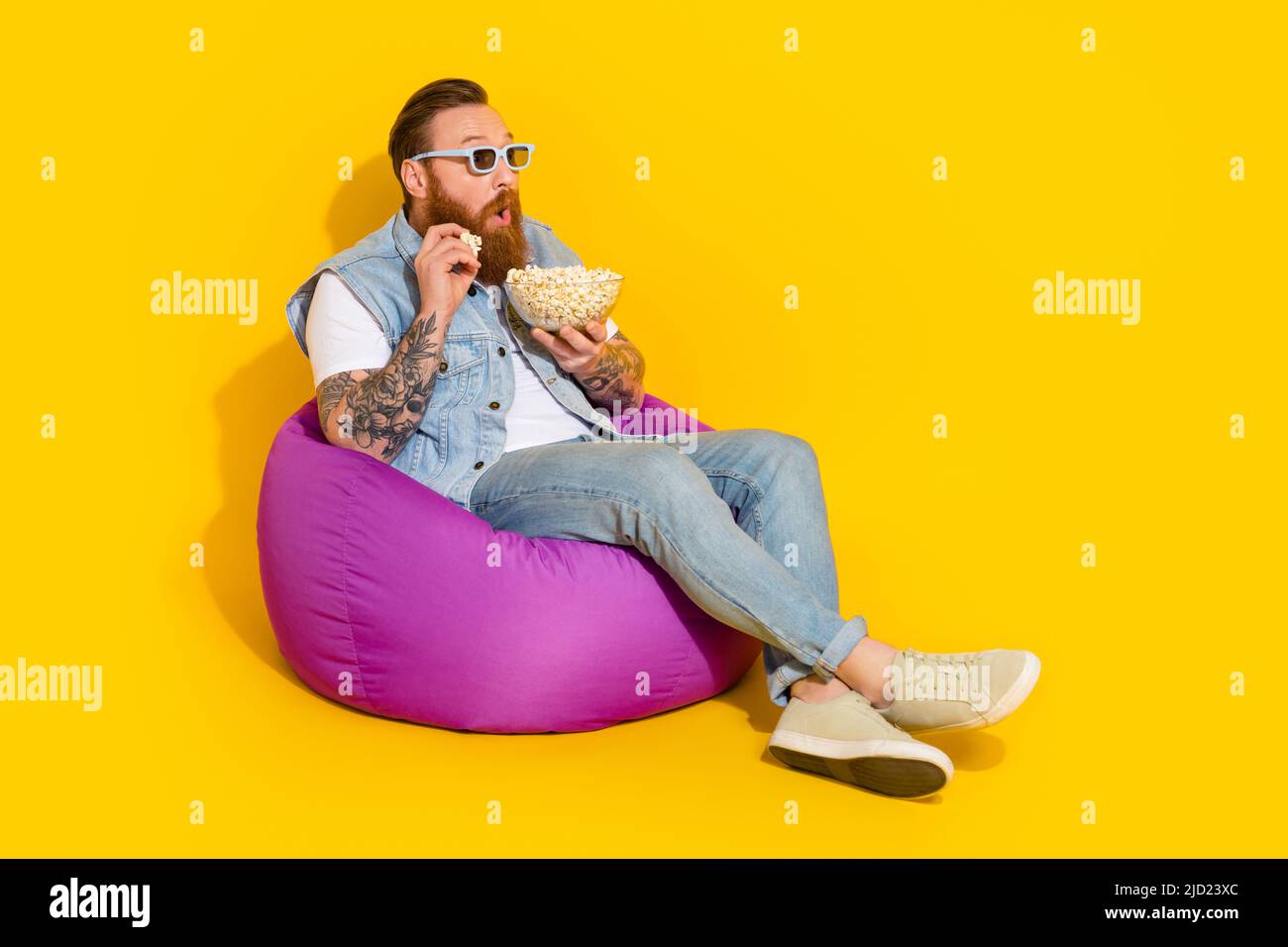 Photo of impressed funky man wear waistcoat sitting beanbag watching ...