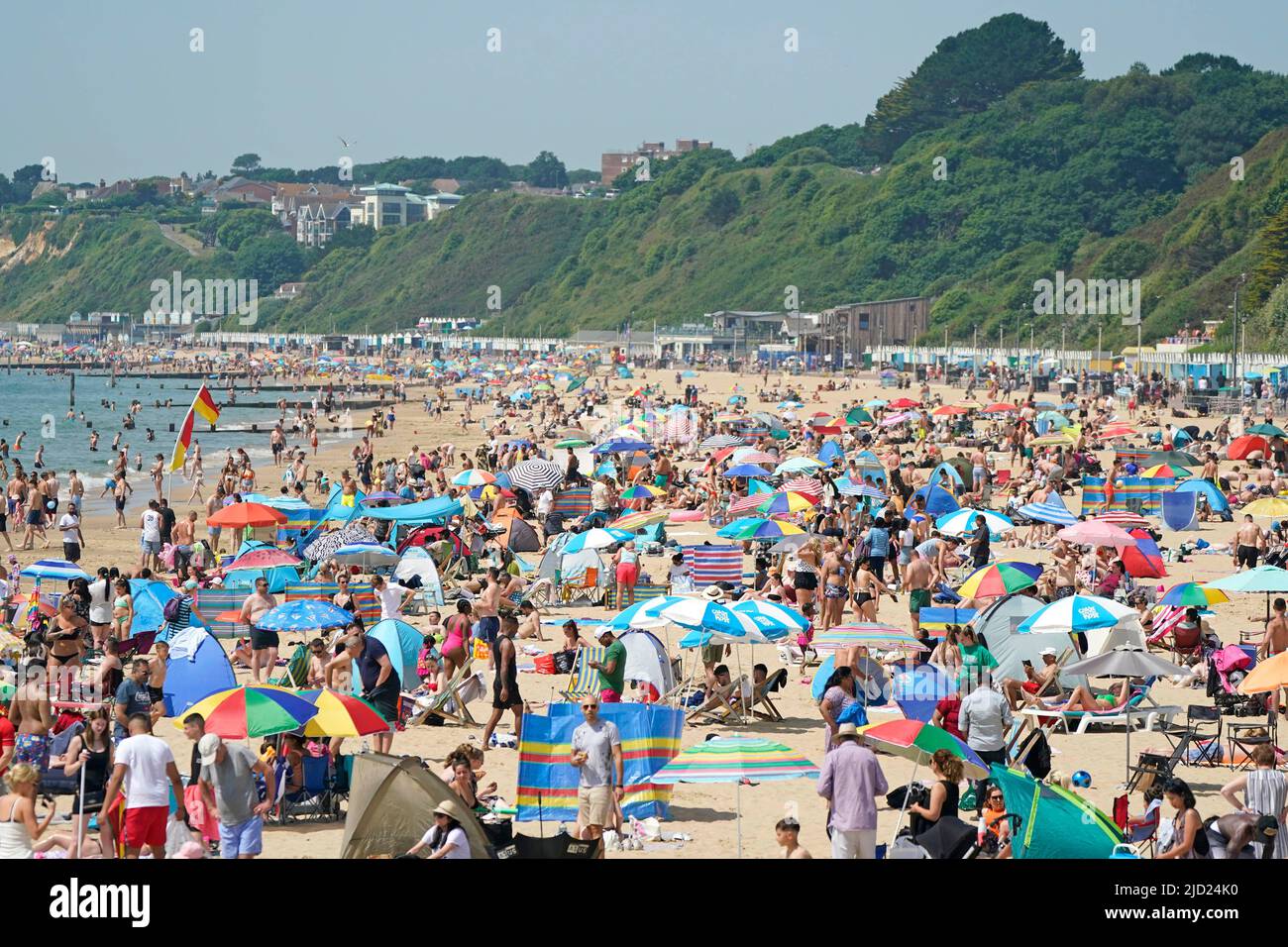 People relax in the hot weather on Bournemouth beach in Dorset. A ...