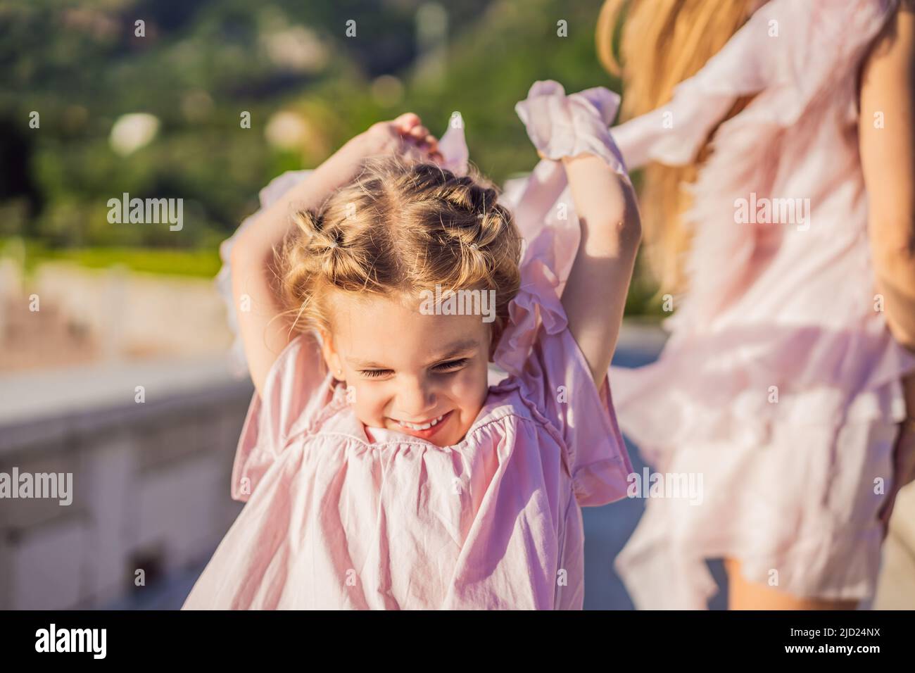 Emotional little girl in a pink dress Stock Photo - Alamy
