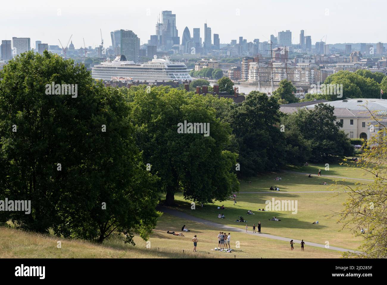 The public enjoy a hot evening on the grass during a June heatwave in ...