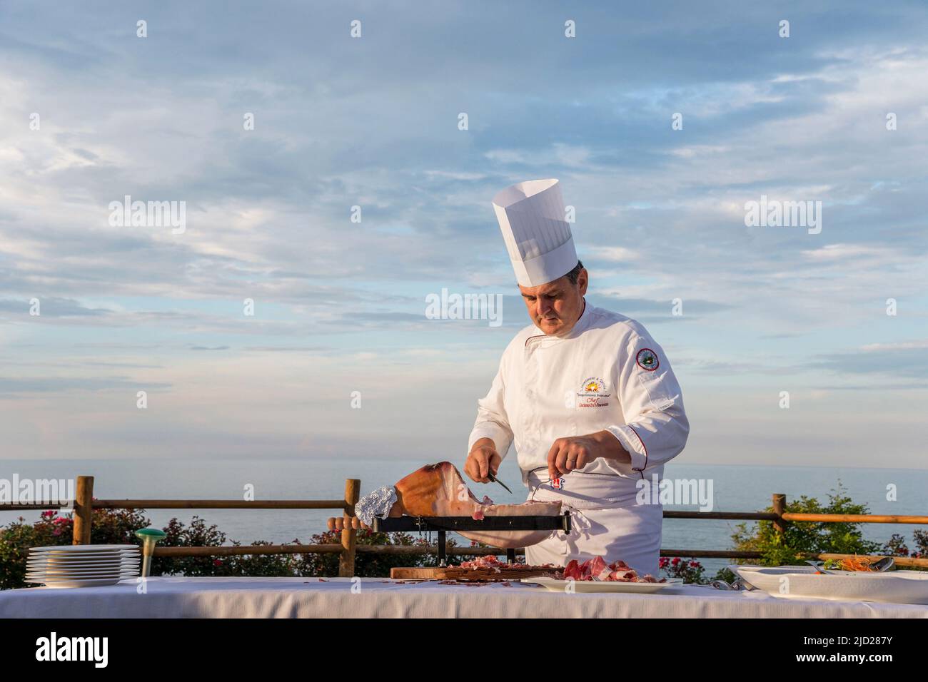 Termoli(CB),Molise Region,Italy:A chef slices ham by hand that will be ...