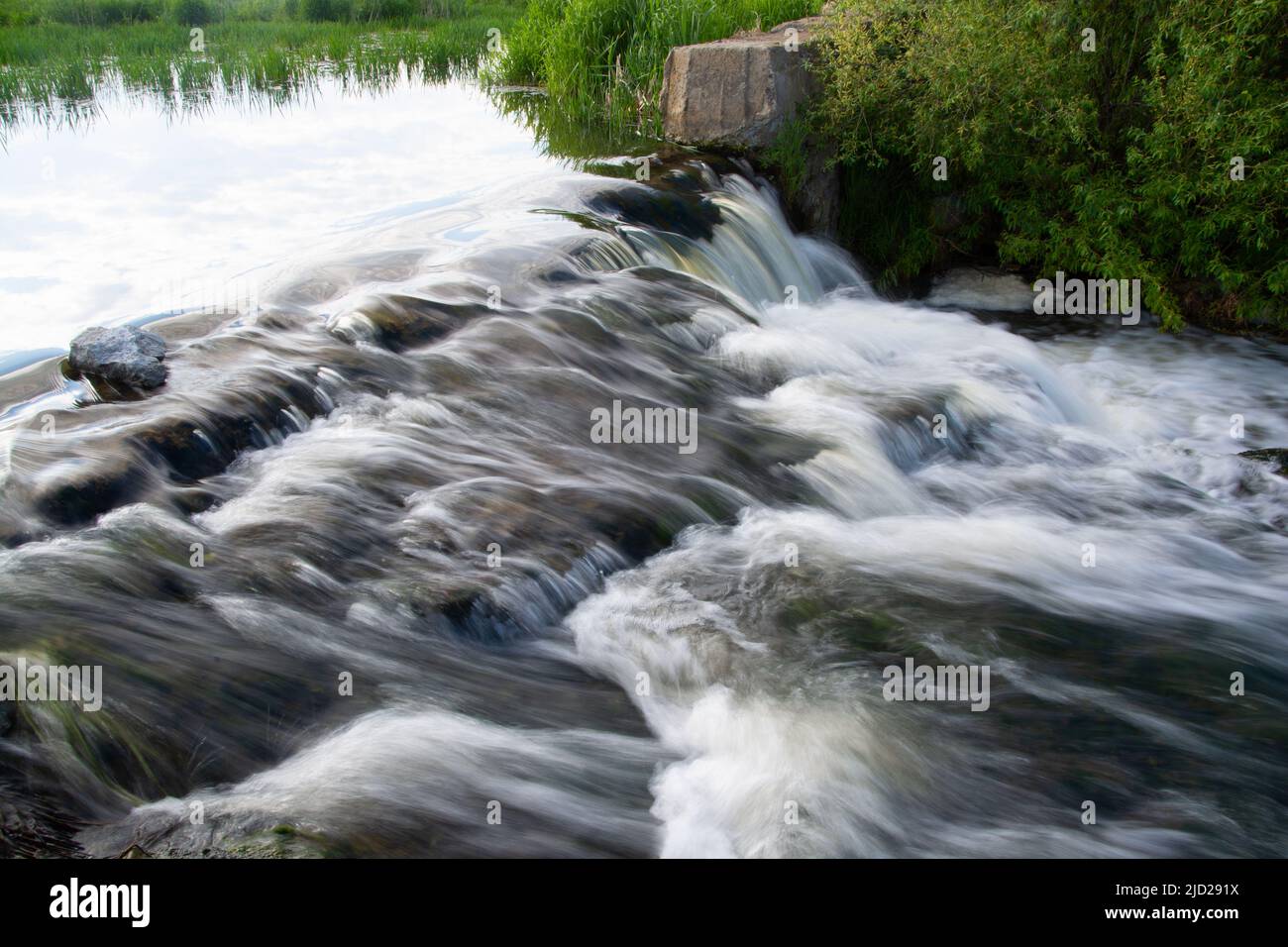 a small river waterfall on a bright sunny summer day Stock Photo - Alamy