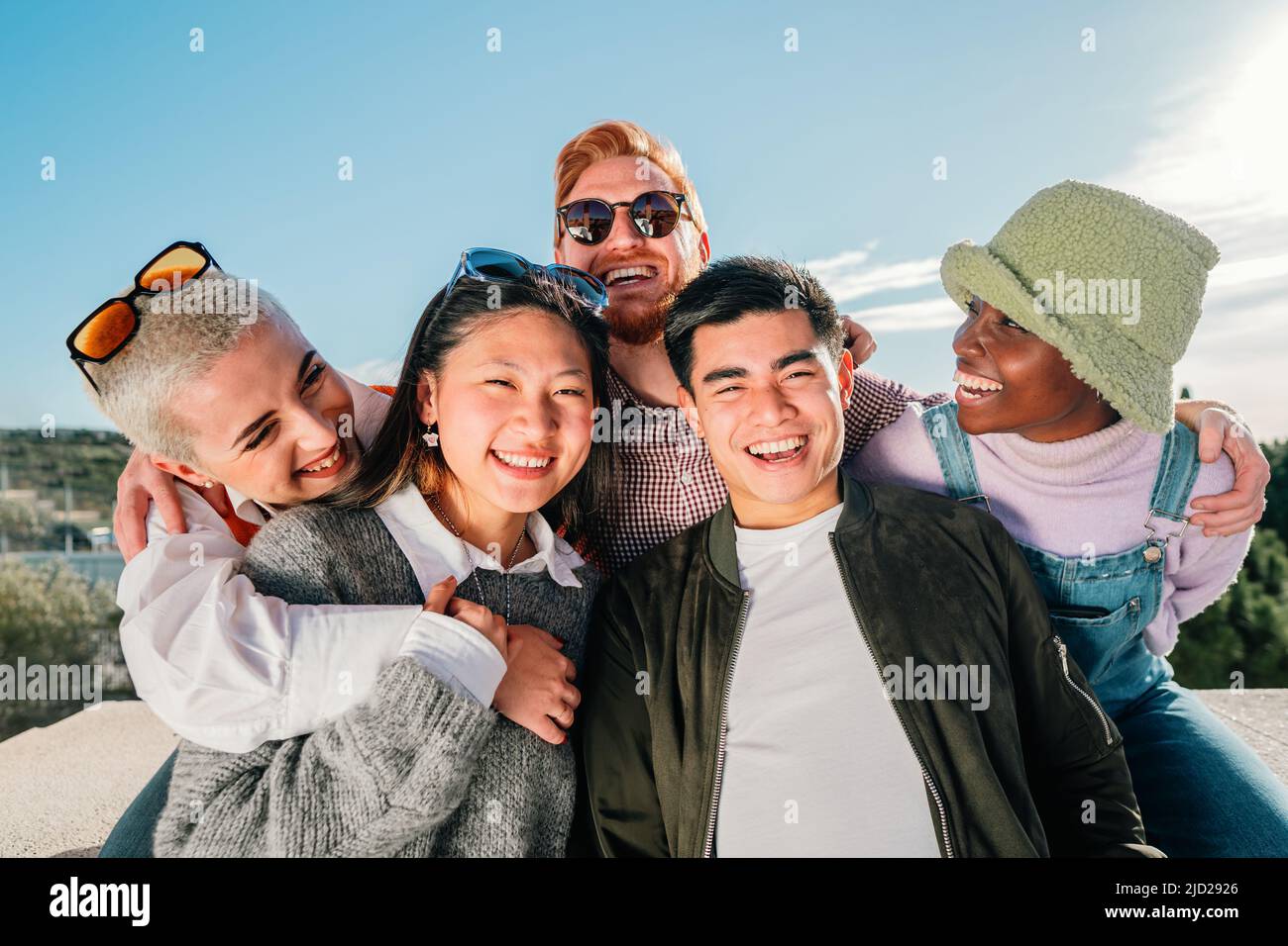 Group young multiracial people having fun smiling outdoors Stock Photo - Alamy