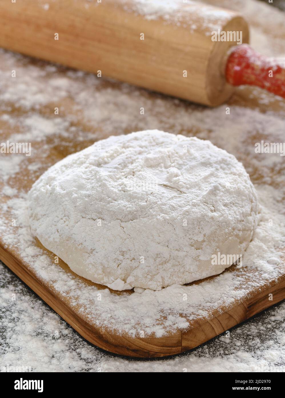 Baking dough covered in flour with rolling pin in background Stock ...
