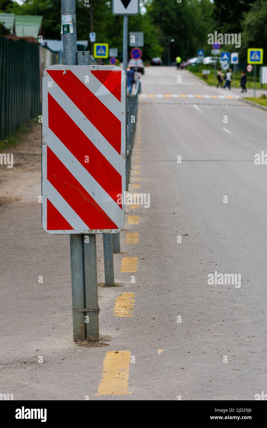 red and white diagonal striped sign at road fence end Stock Photo - Alamy