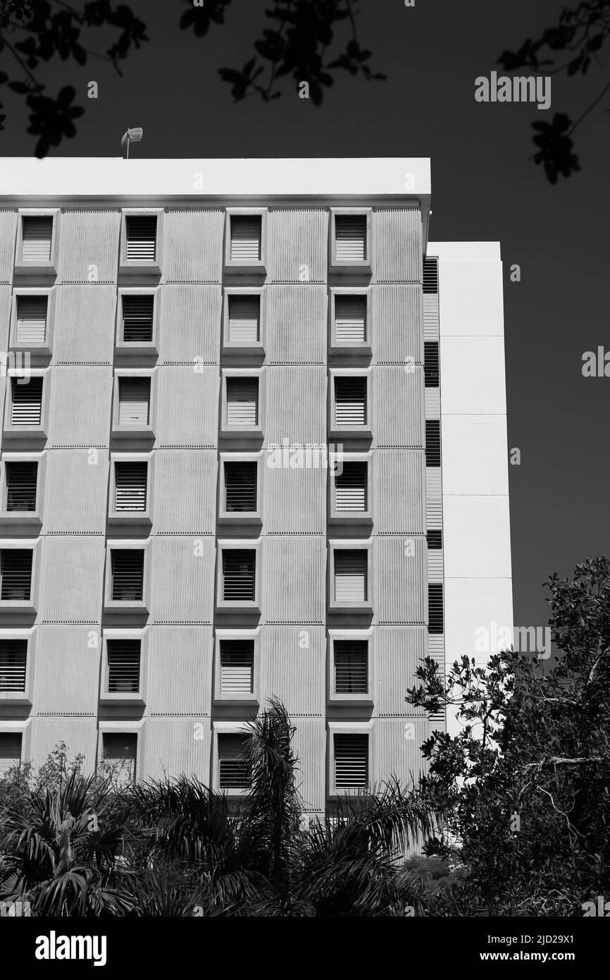 Simple and plain tropical building with several floors and many windows ...