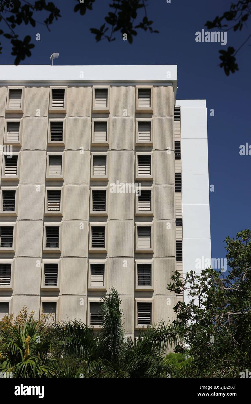 Simple and plain tropical building with several floors and many windows ...