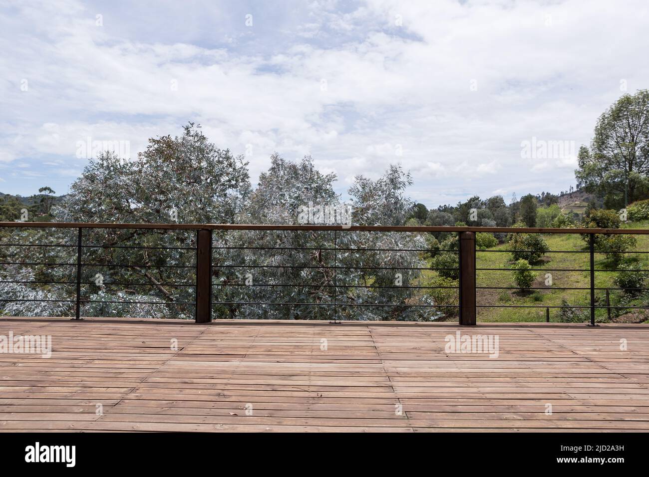 Large wood deck near house with spring landscape Stock Photo - Alamy