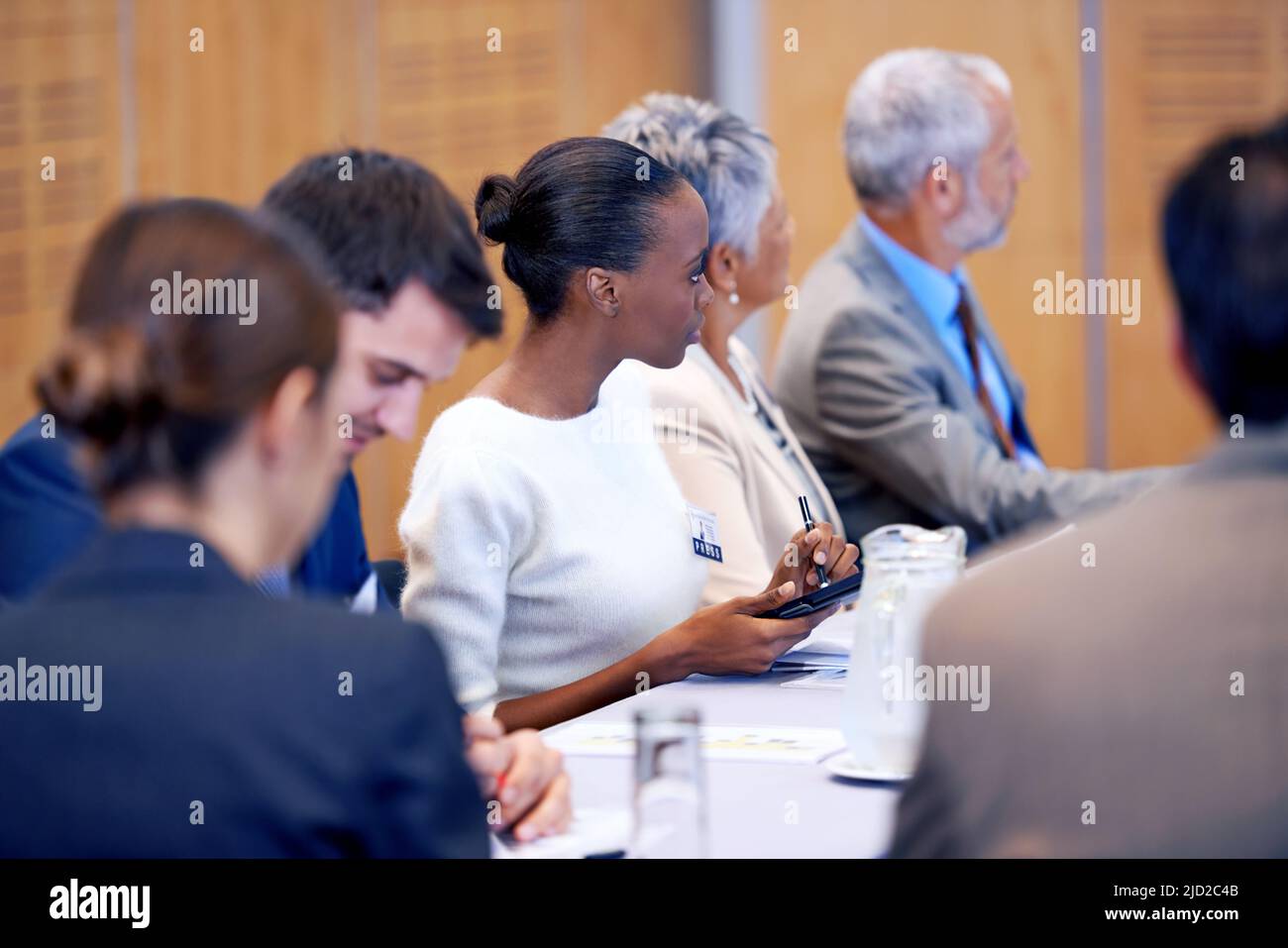 Getting the facts straight. A cropped shot of members of the press at a ...