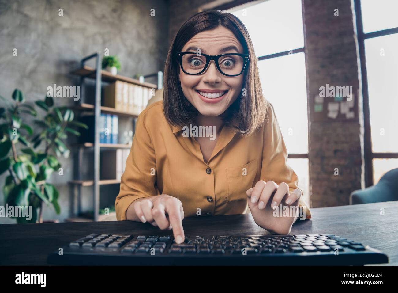 Portrait of positive funny lady finger press keyboard look camera ...