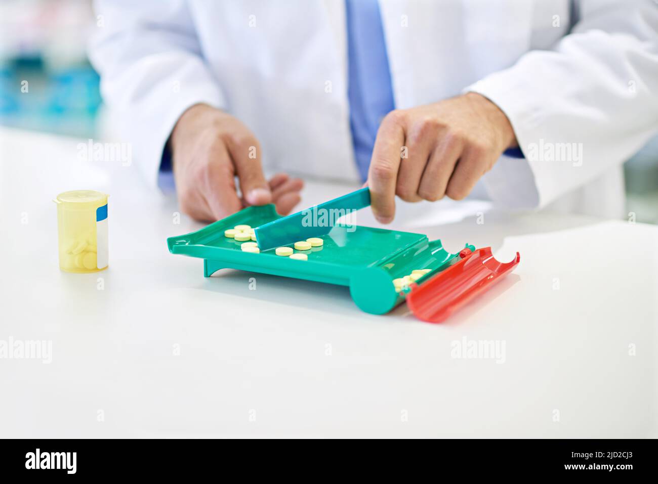 Counting out the right amount for the prescription. A pharmacist ...