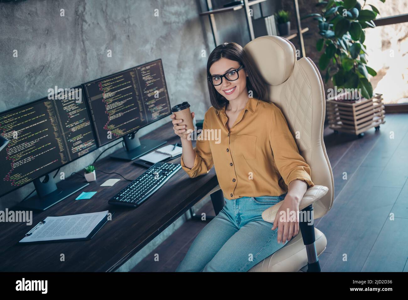 Portrait of beautiful cheerful intellectual girl geek drinking latte ...