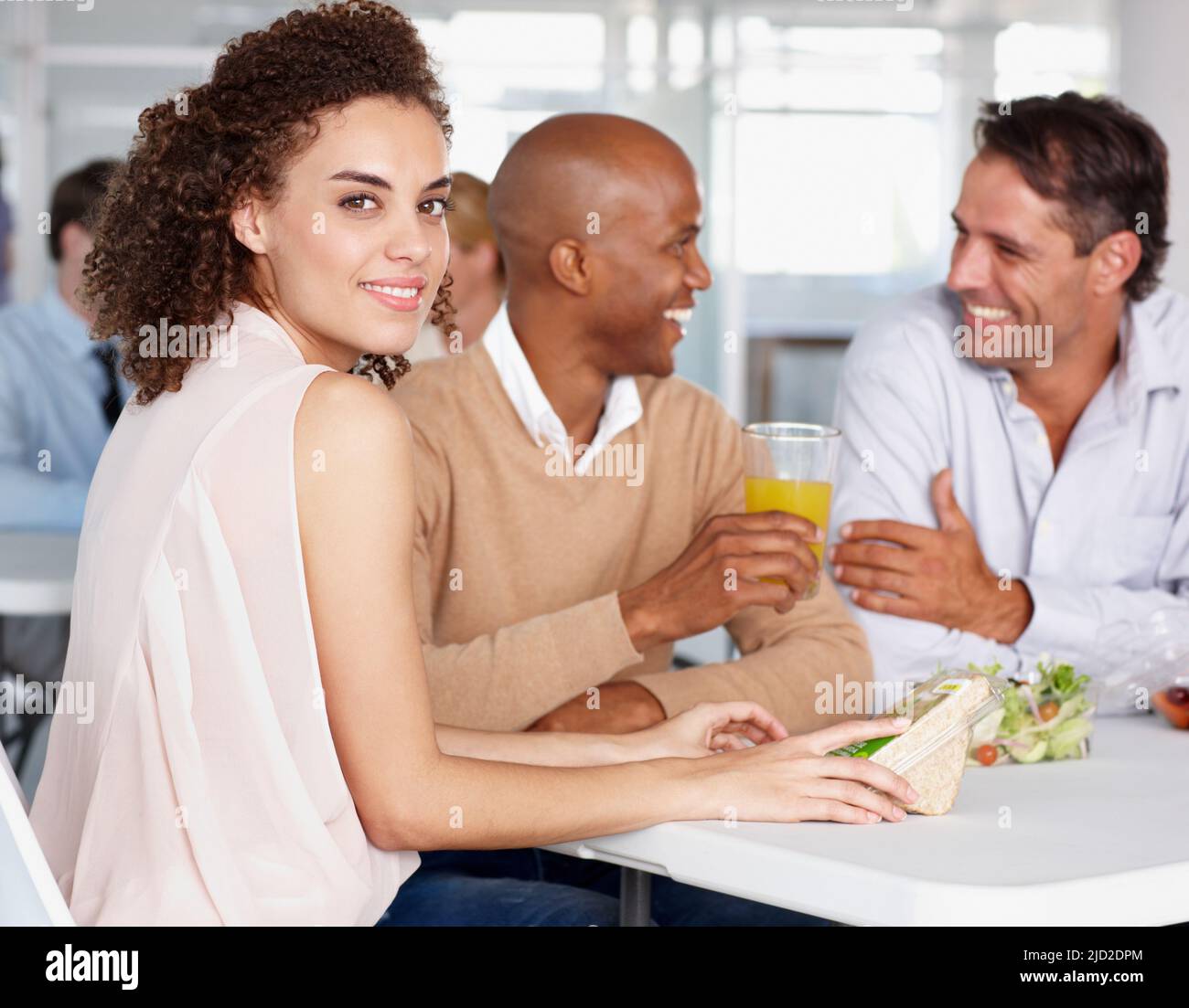 Networking over a sandwich.... A pretty young woman enjoying lunch with ...