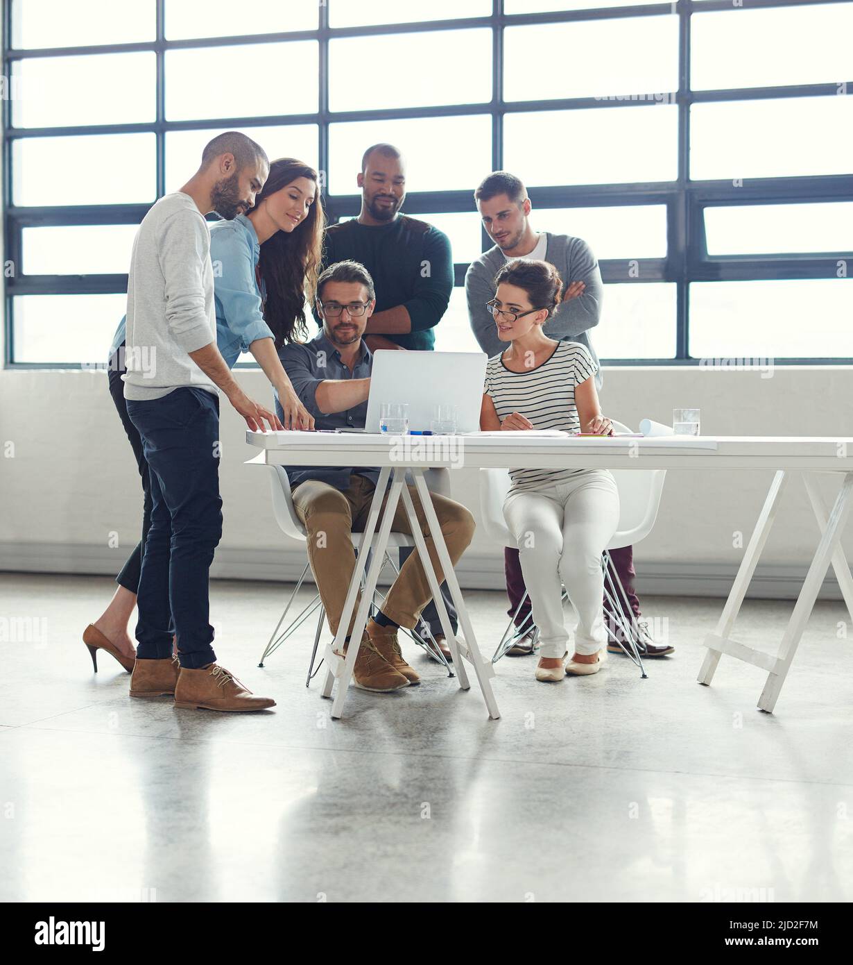 Sharing his expertise with the team. Shot of a group of coworkers ...