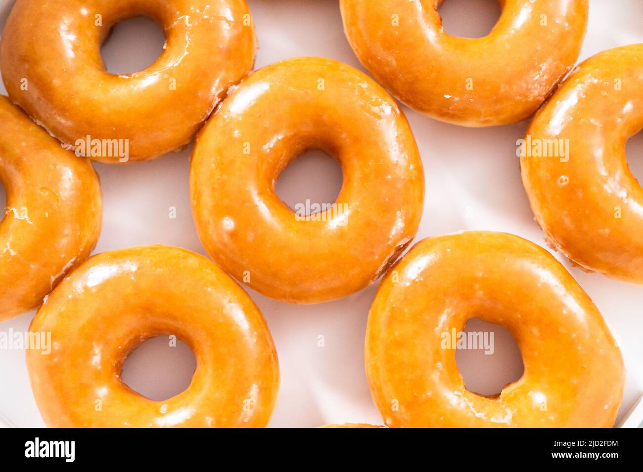 Plain glazed store-bought doughnuts in a white paper box Stock Photo ...