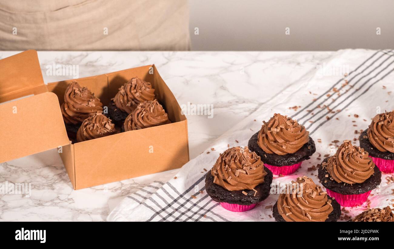 Step by step. Packaging chocolate cupcakes with chocolate ganache ...