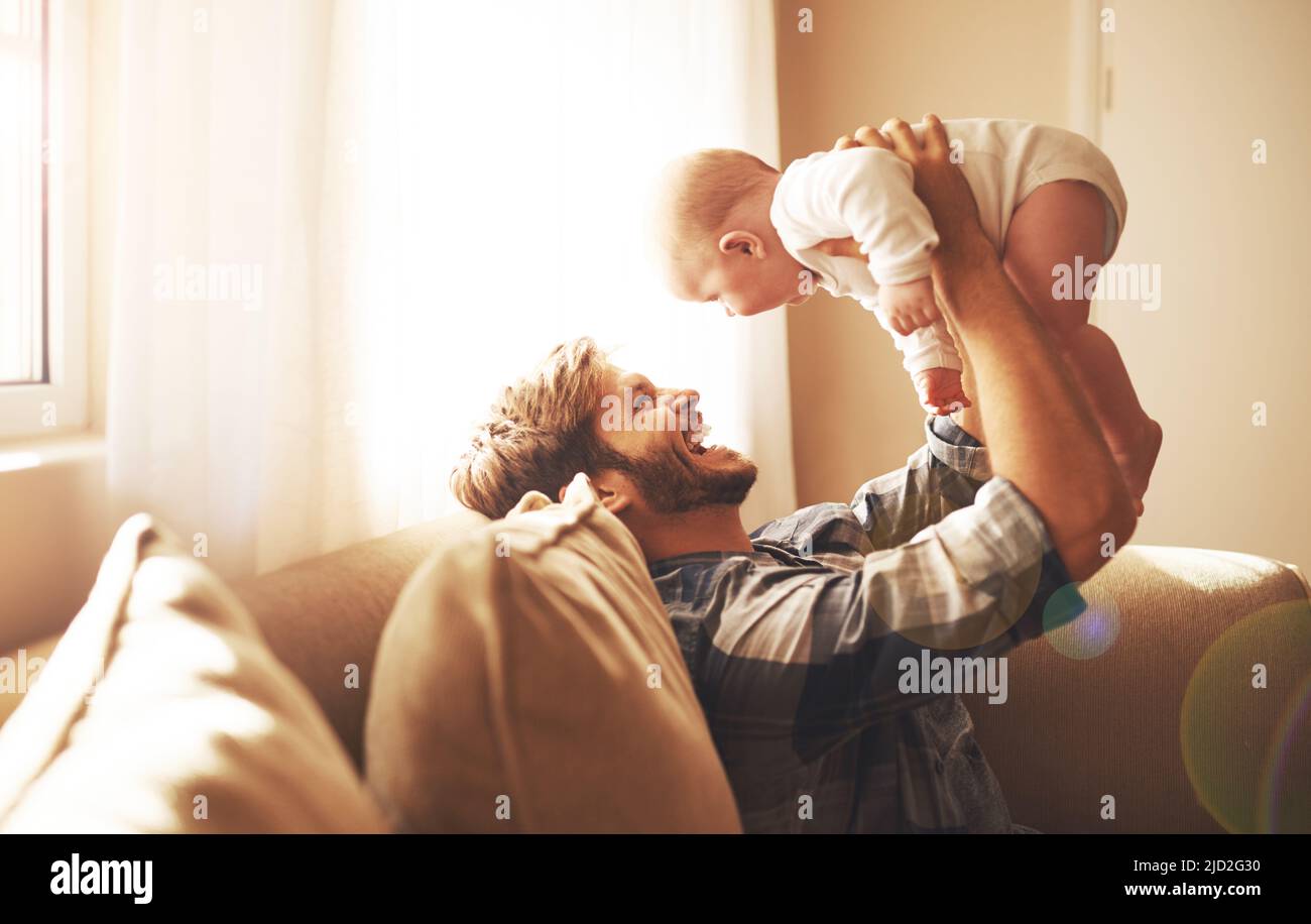 Raising his boy with so much love. Cropped shot of a young father and ...