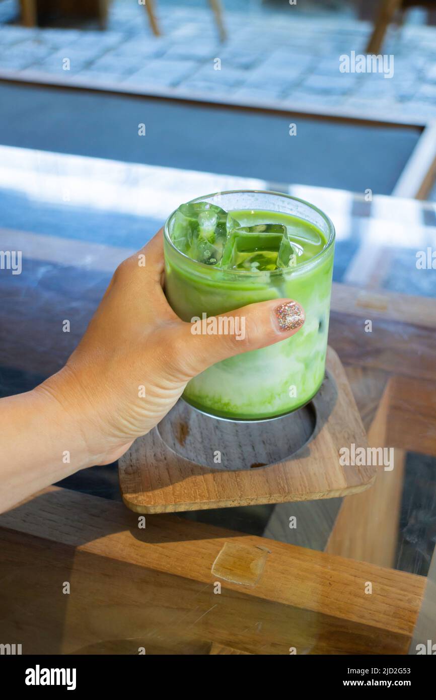 Hand on iced matcha green tea drink, stock photo Stock Photo - Alamy