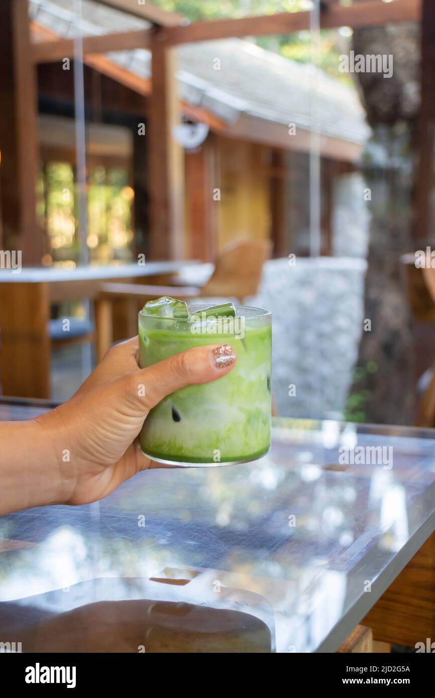 Hand on iced matcha green tea drink, stock photo Stock Photo - Alamy