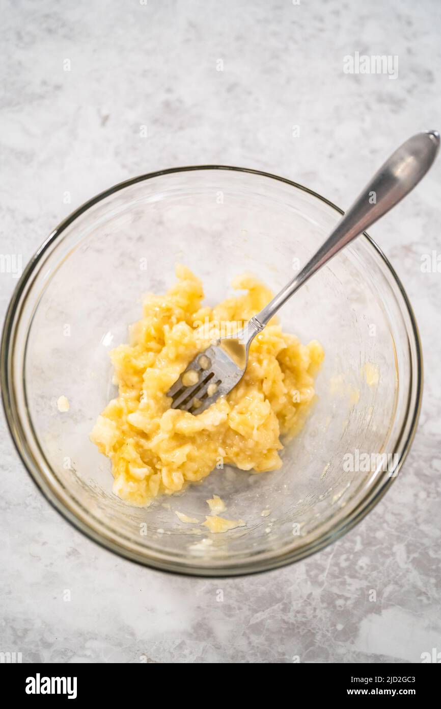 Mashing overhyped banana with a fork Stock Photo - Alamy
