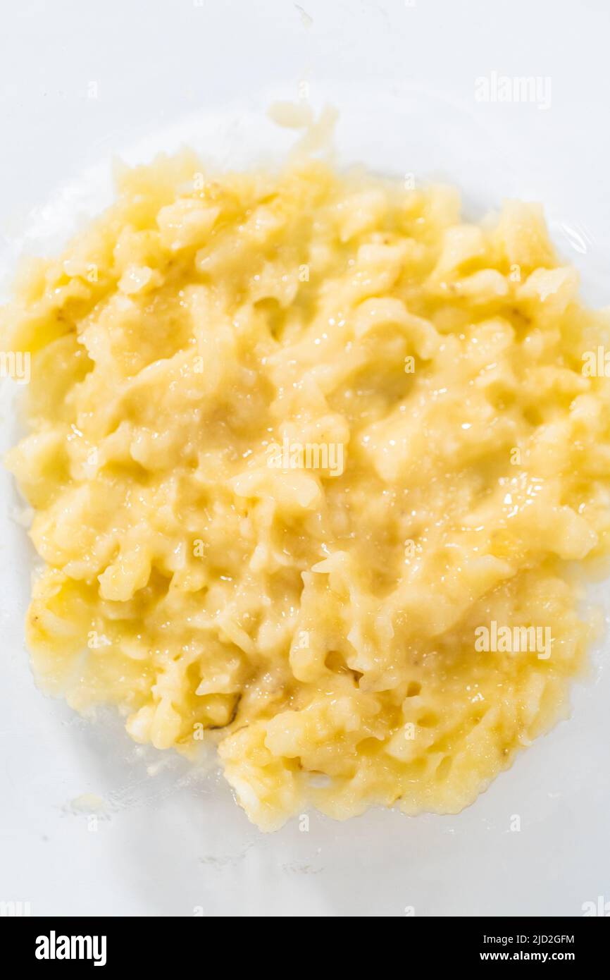 Mashed overripe banana in a glass mixing bowl Stock Photo - Alamy