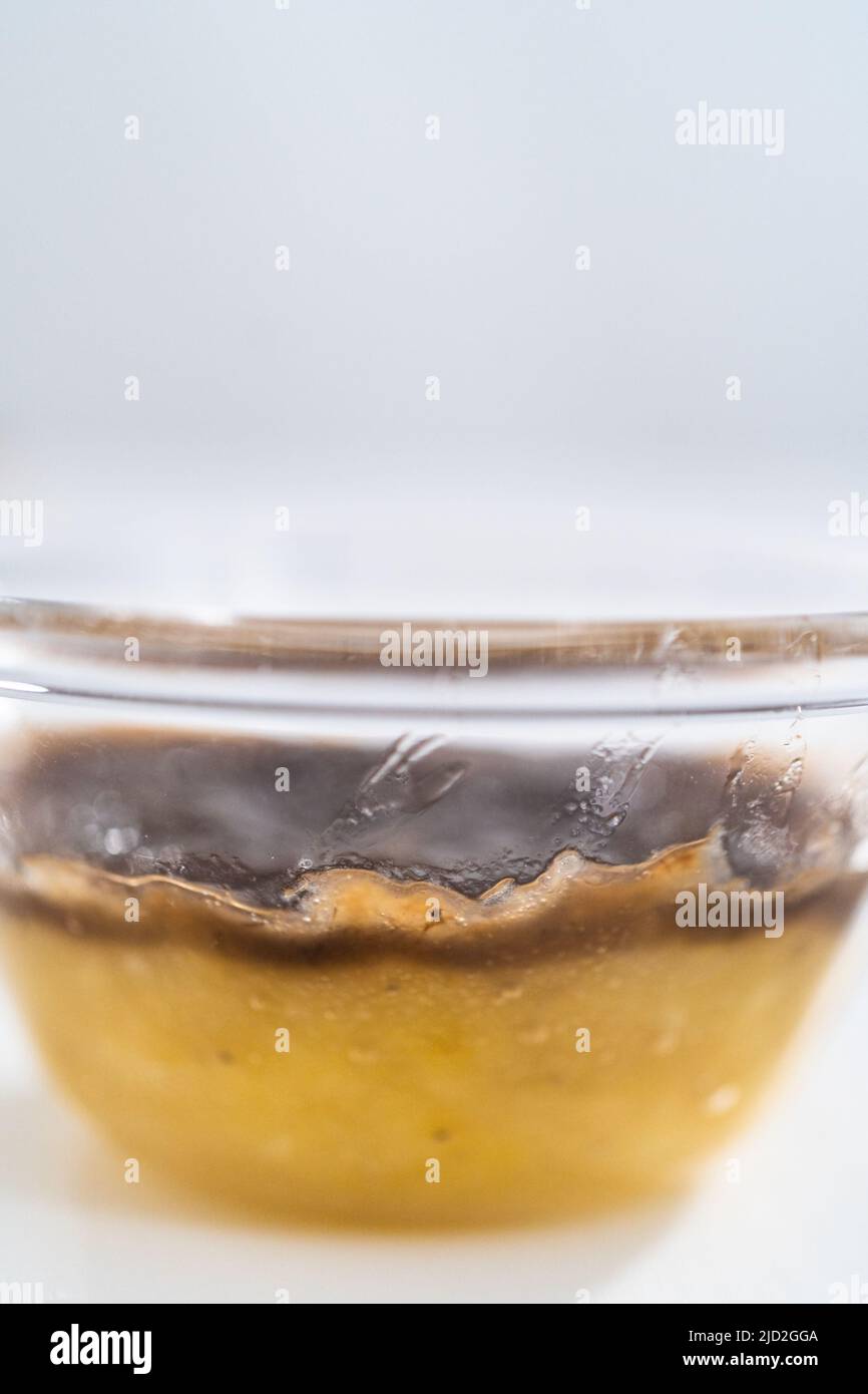 Mashed overripe banana in a glass mixing bowl Stock Photo - Alamy