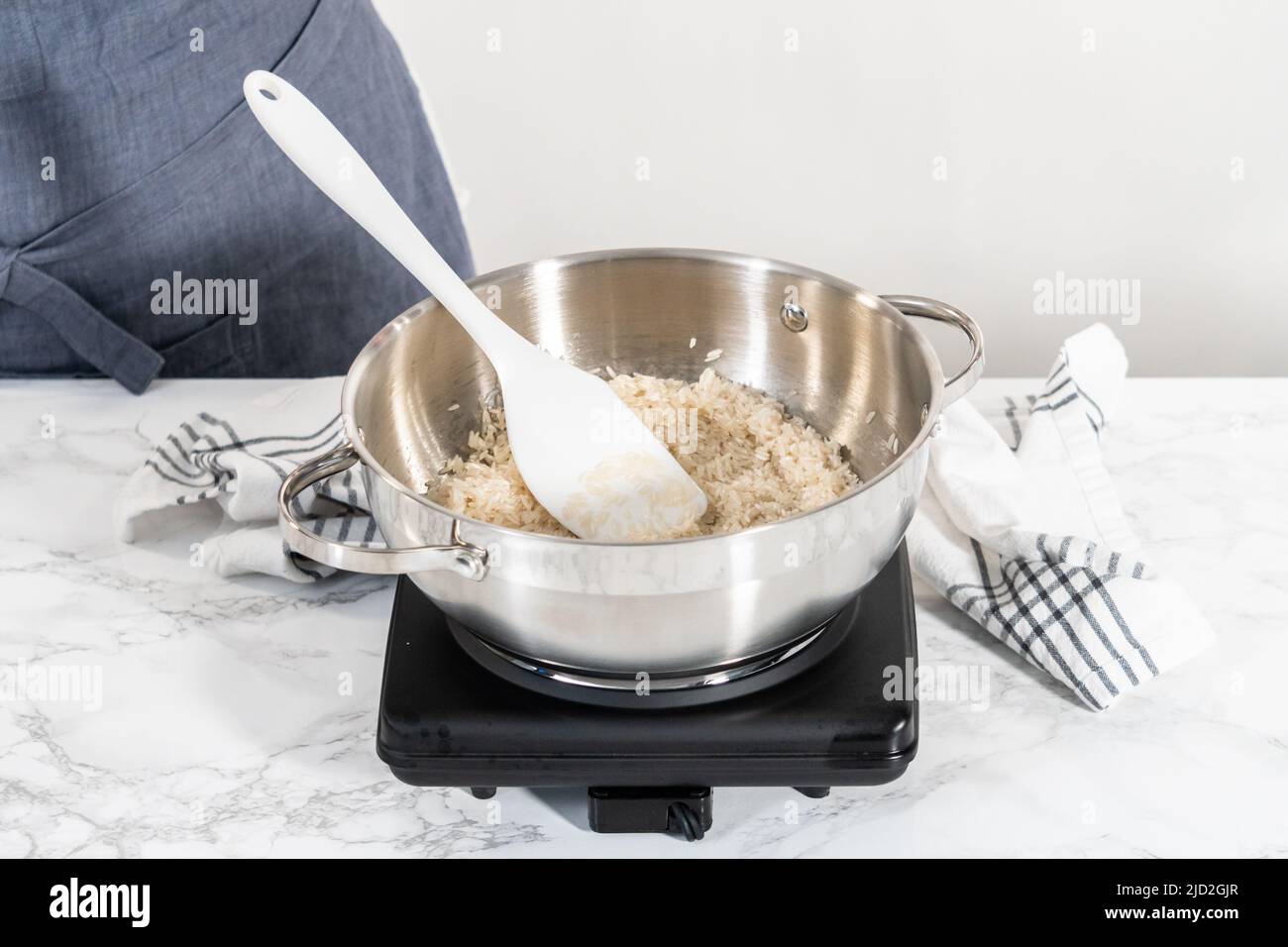 Cooking Mexican rice in a stainless steel cooking pot Stock Photo - Alamy