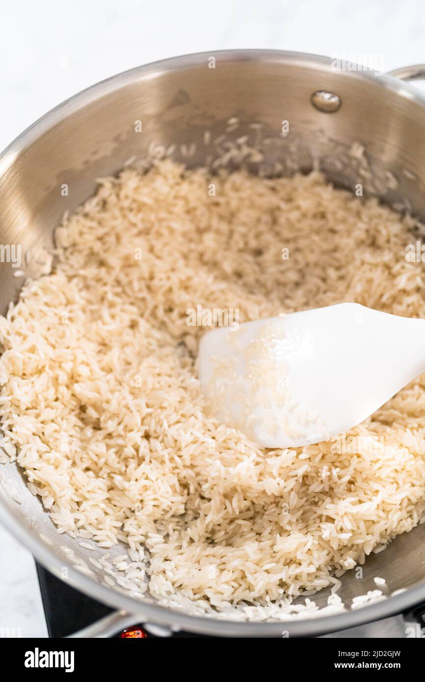 Cooking Mexican rice in a stainless steel cooking pot Stock Photo - Alamy