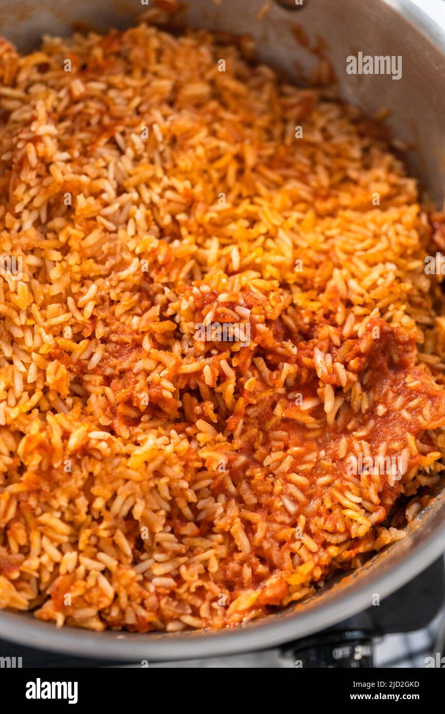 Cooking Mexican rice in a stainless steel cooking pot Stock Photo - Alamy