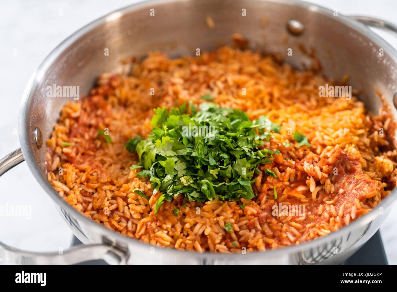 Cooking Mexican rice in a stainless steel cooking pot Stock Photo - Alamy