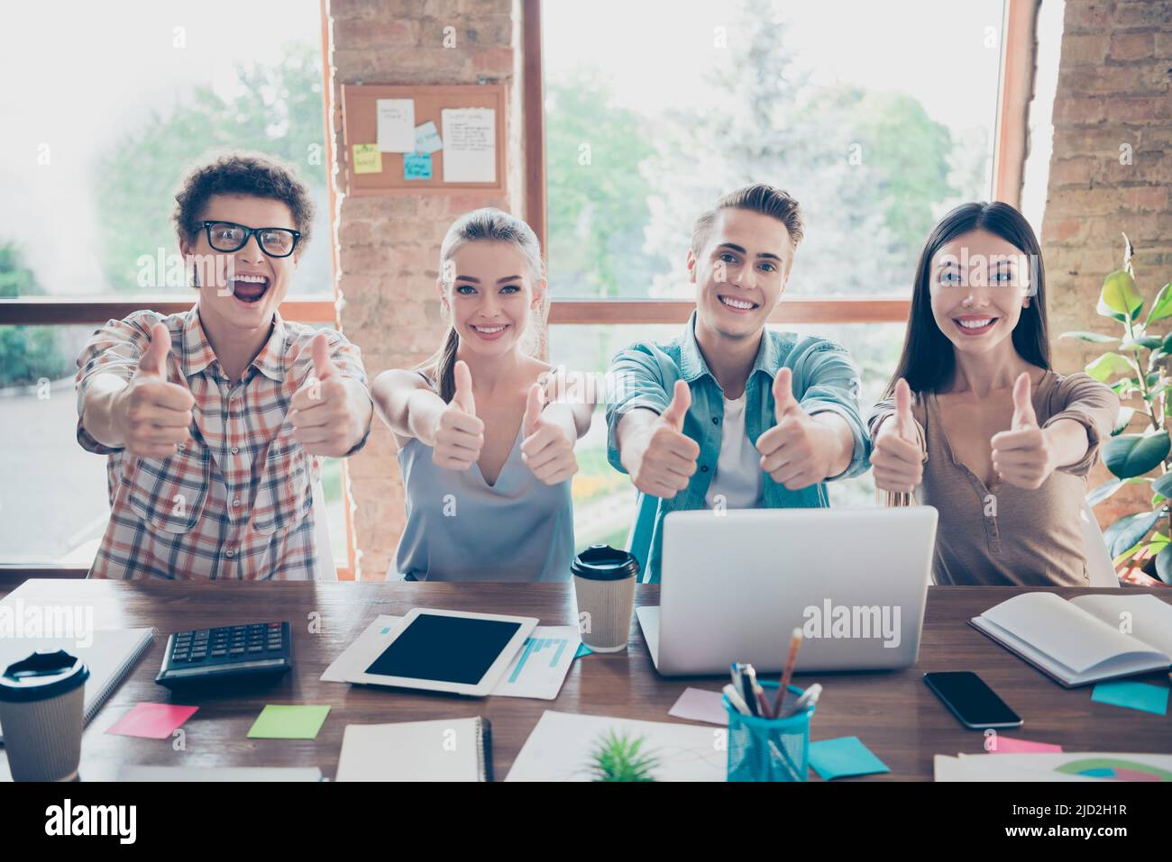 Photo of positive funky groupmates showing you big thumbs up give ...