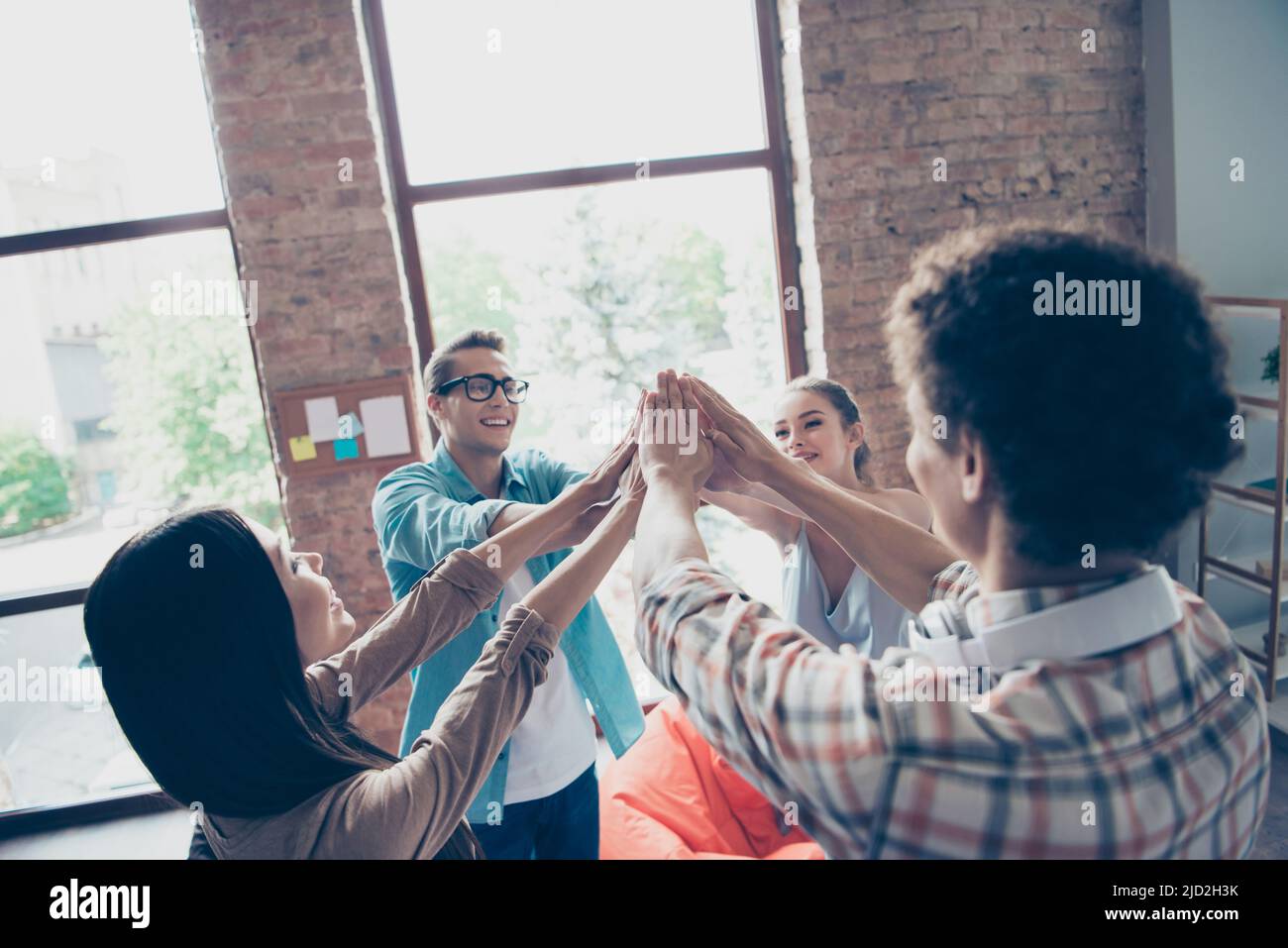 Photo of group positive friendly partners hands palms give high five ...
