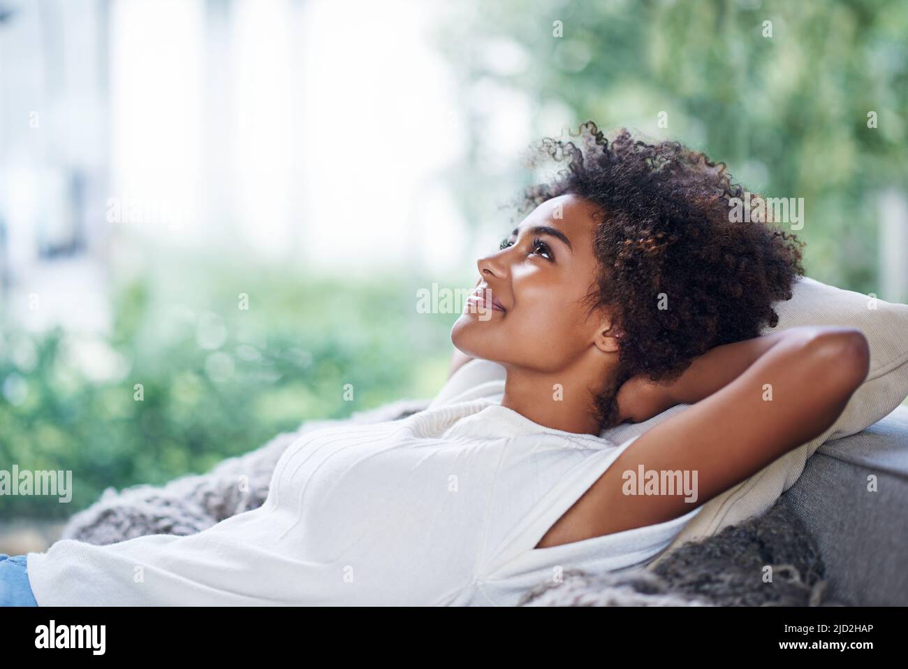 Afro american woman relaxing on couch hi-res stock photography and ...
