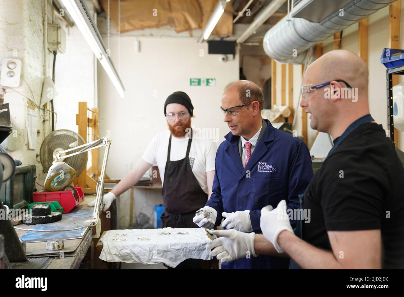 The Earl of Wessex, polishing a Commonwealth games medal during a visit ...