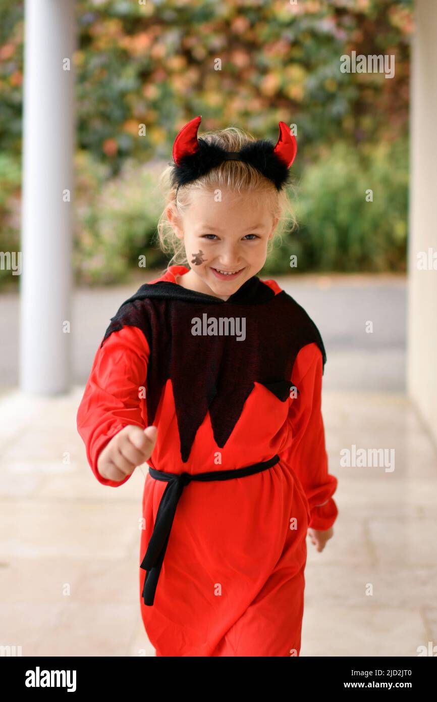 Scary girl dressed as a devil with horns Stock Photo - Alamy