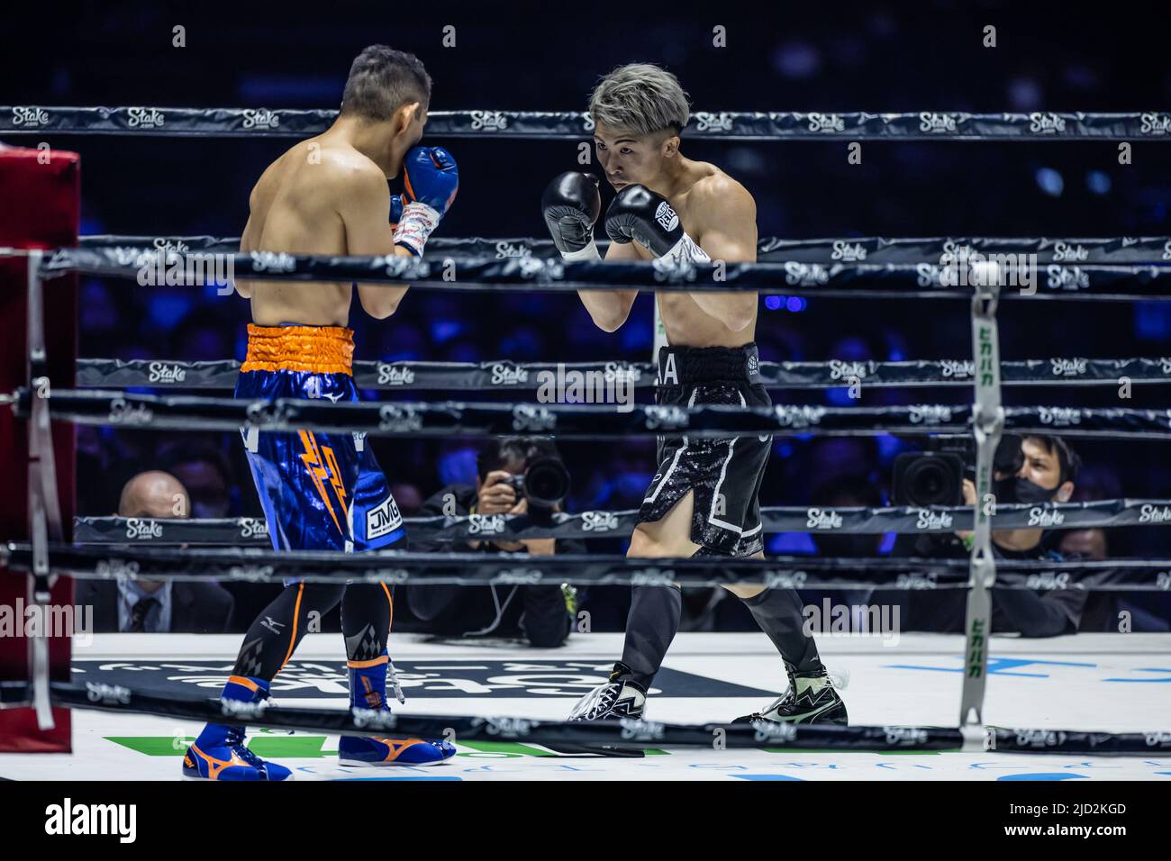 Naoya Inoue (black gloves) of Japan and Nonito Donaire (blue gloves) of ...