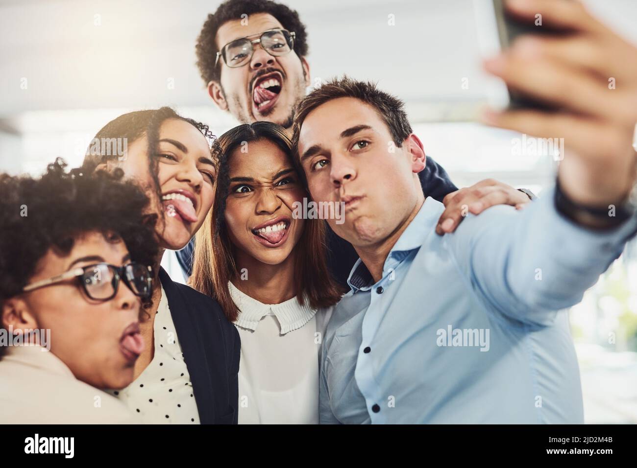 Try and look serious guys. Shot of a group of cheerful work colleagues ...